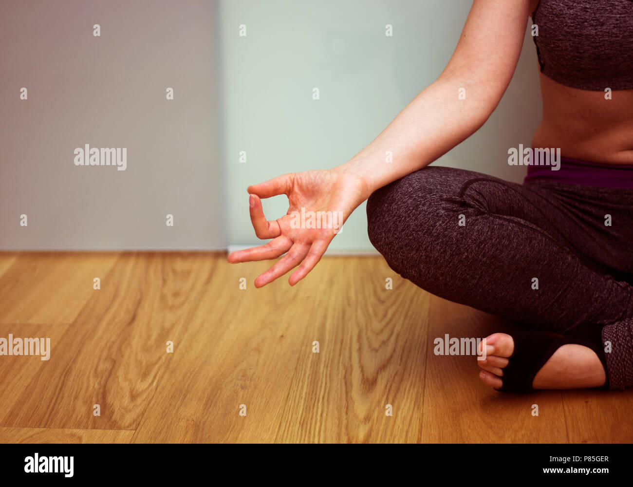 Female instructor yoga teacher teaching asana pose with mudra hand ...