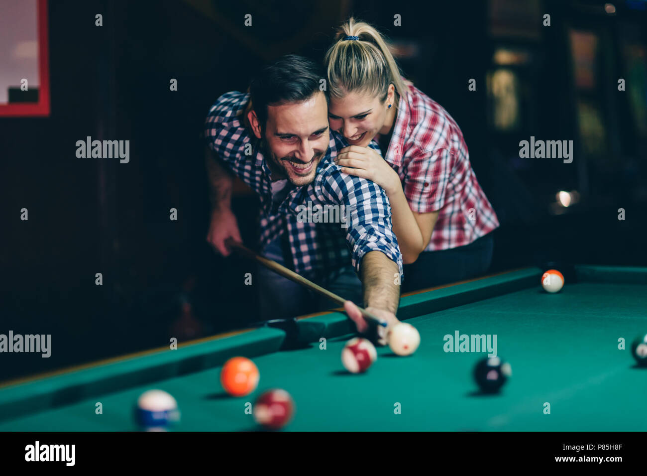 Young couple playing snooker together in bar Stock Photo - Alamy