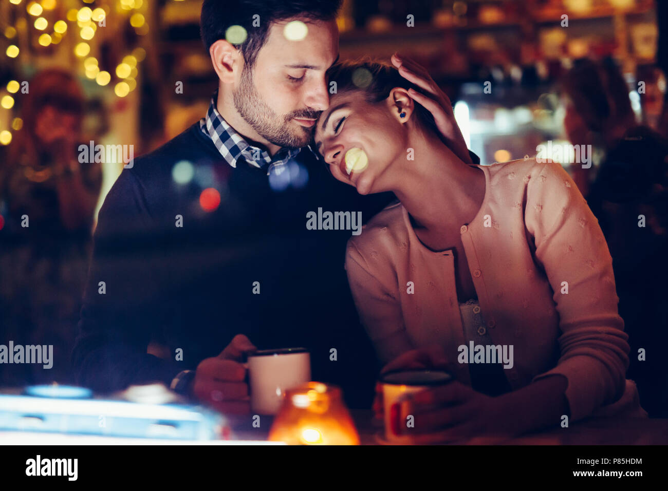 Romantic couple dating in pub at night Stock Photo - Alamy