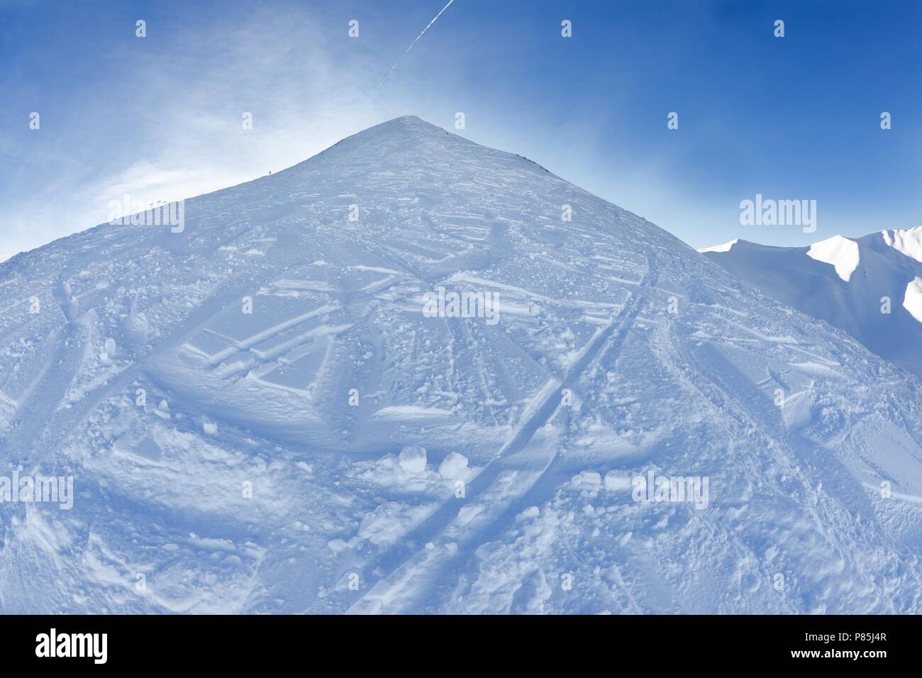 Skier marks in the snow on a steep slope Stock Photo - Alamy