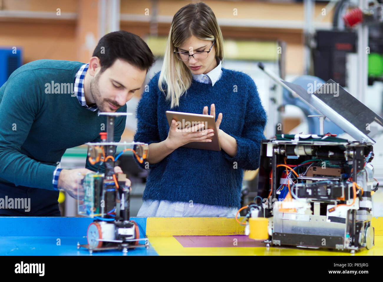 Young students of robotics working on project Stock Photo - Alamy