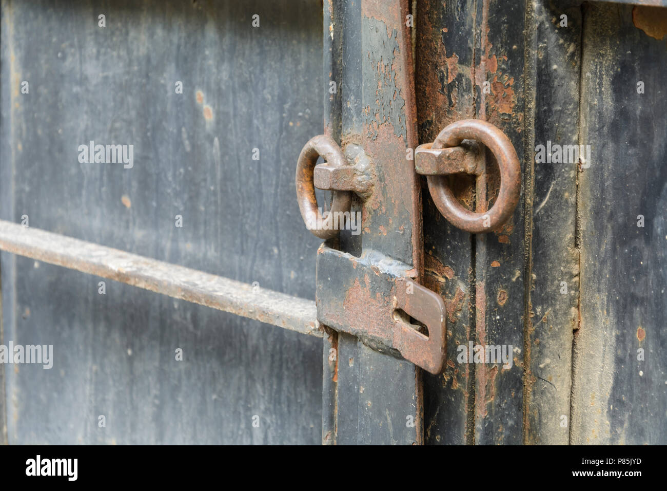 iron door with old opened lock with rusty rings Stock Photo - Alamy