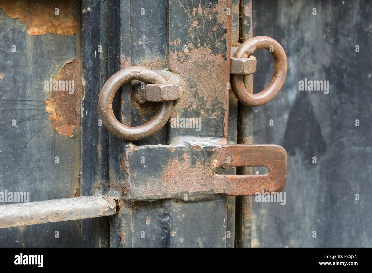 iron door with old opened lock with rusty rings Stock Photo - Alamy