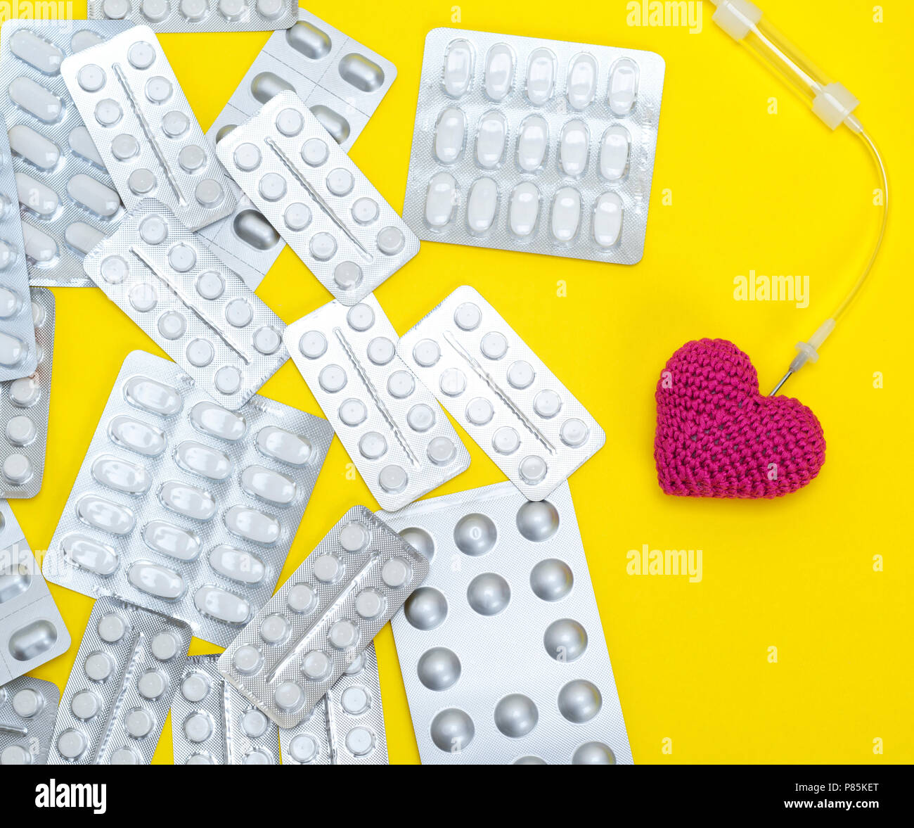 red heart and catheter on a yellow background and packages with white ...