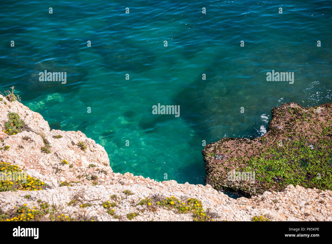 high cliff above the sea, summer sea background, many splashing waves ...