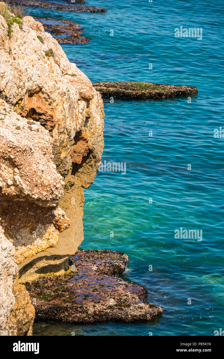 high cliff above the sea, summer sea background, many splashing waves ...