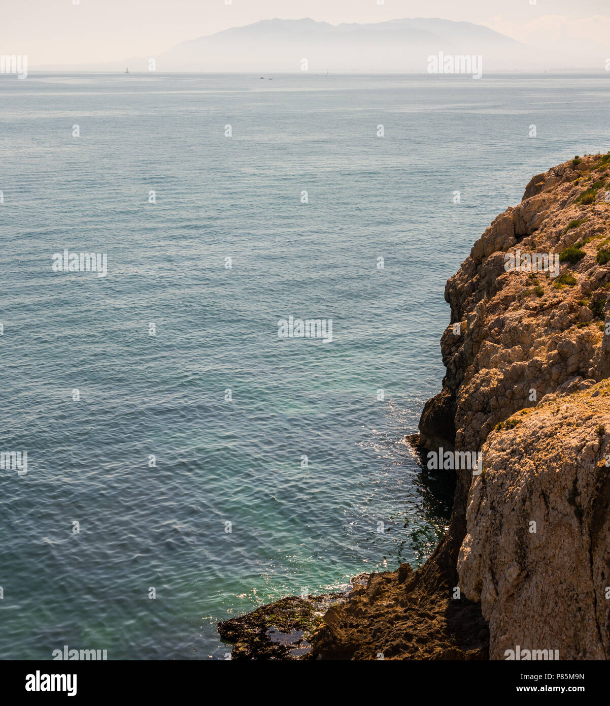 high cliff above the sea, summer sea background, many splashing waves ...