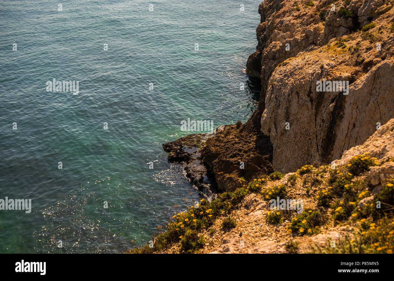 high cliff above the sea, summer sea background, many splashing waves ...