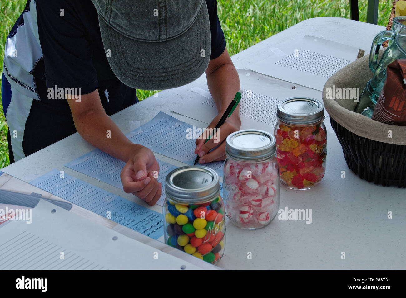 Silent auction table with candy count jars and kids guessing count ...