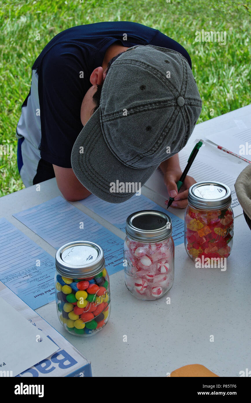 Silent auction table with candy count jars and kids guessing count ...