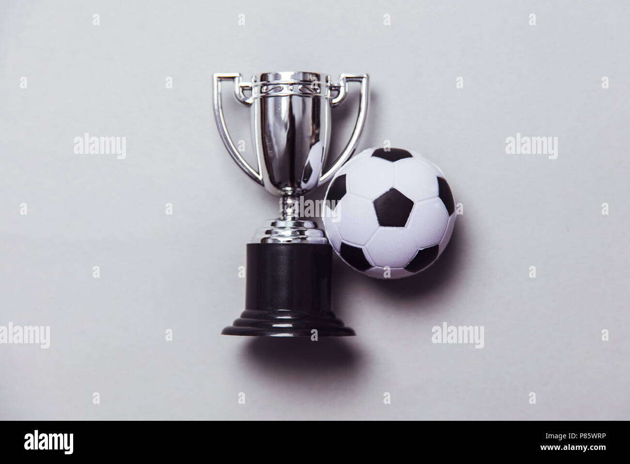 Soccer ball with a silver winning trophy Stock Photo - Alamy