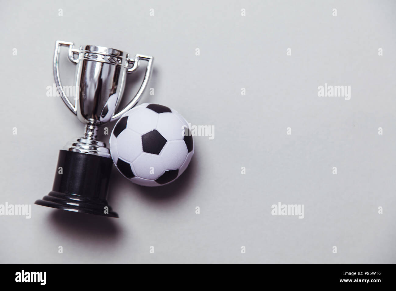 Soccer ball with a silver winning trophy Stock Photo - Alamy