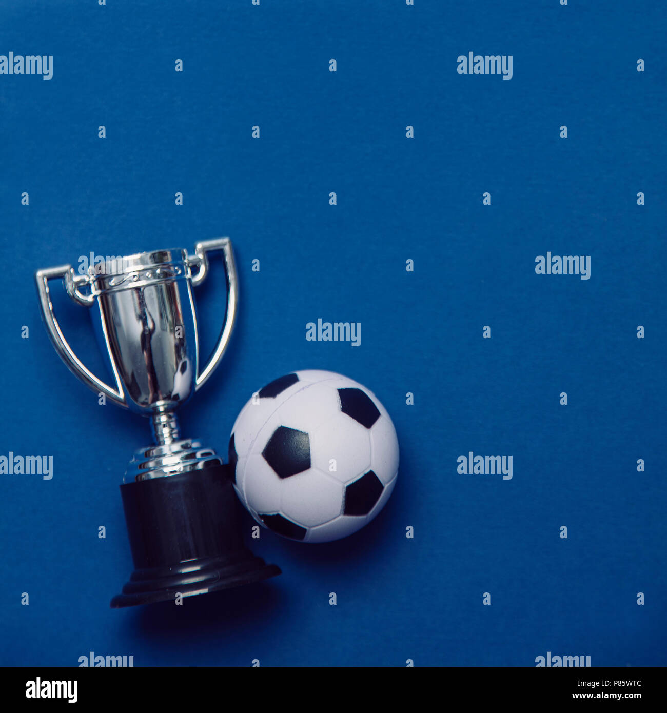 Soccer ball with a silver winning trophy Stock Photo - Alamy