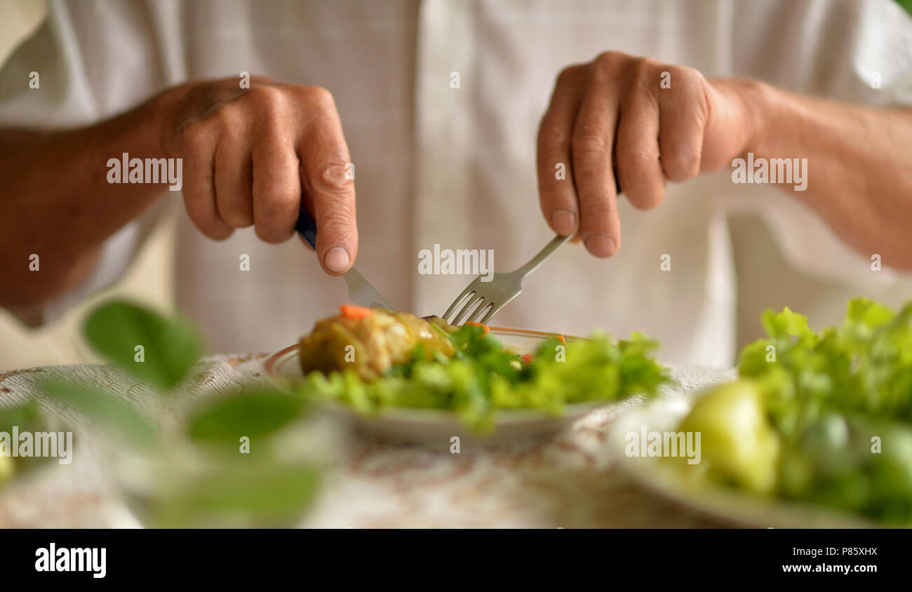 Cropped image of senior man eating Stock Photo - Alamy