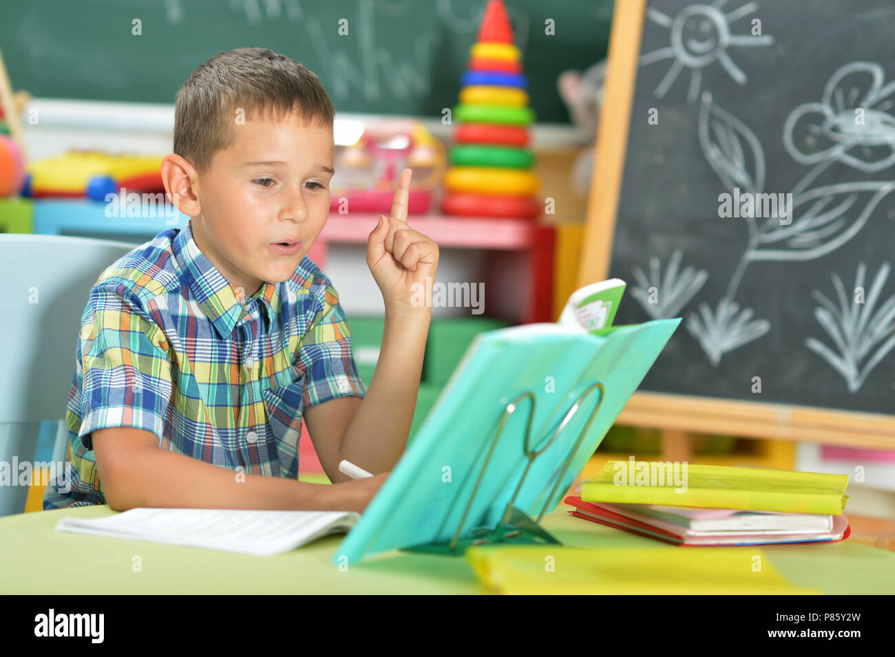 Young boy doing homework Stock Photo - Alamy