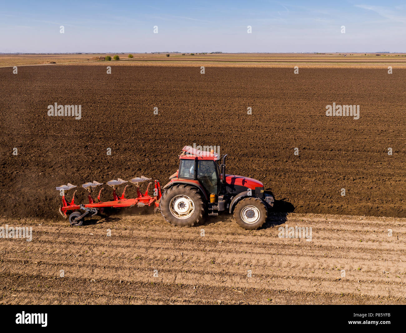 Aerial shot of a farmer plowing stubble field Stock Photo - Alamy
