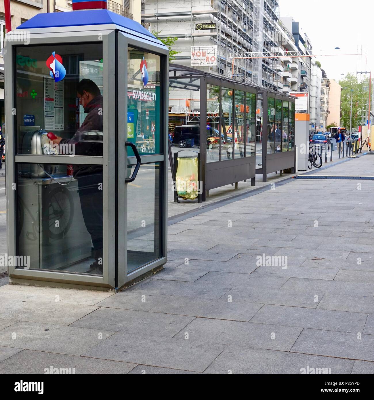 Man making phone call in Swisscom public telephone booth, Geneva ...