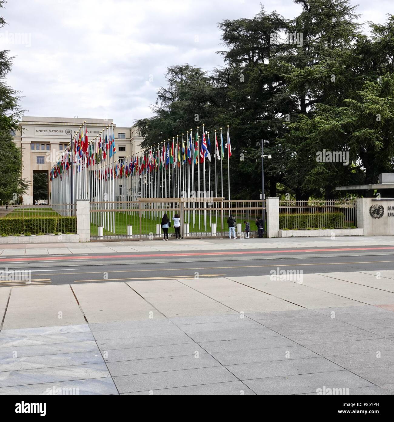 People gather at the gate to the United Nations building and the ...