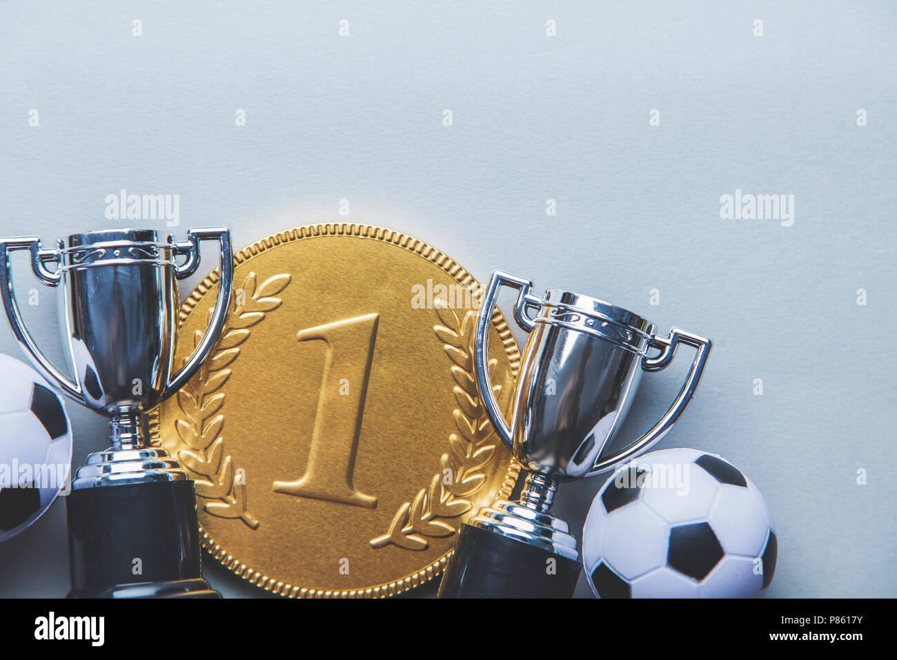 Gold first place winners medal and trophy with a soccer ball. Football ...
