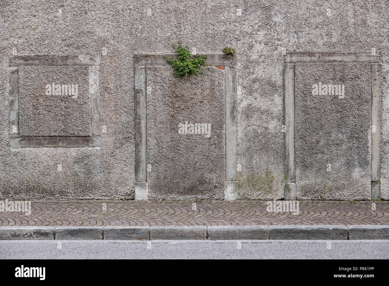 Street wall with walled up doors and window Stock Photo - Alamy