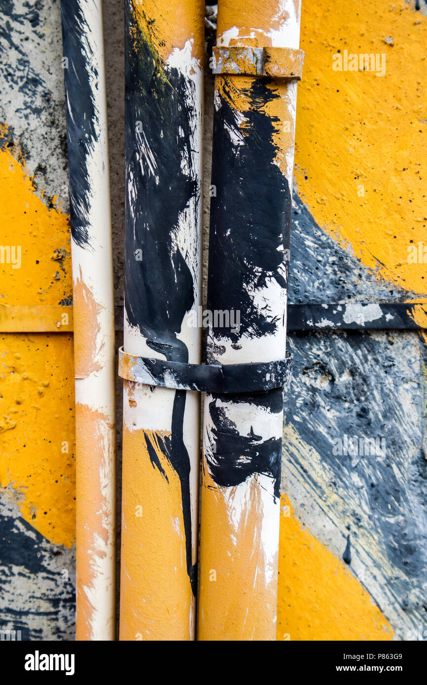 Yellow striped road markings on black asphalt Stock Photo - Alamy