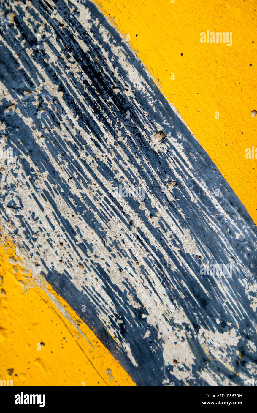 Yellow striped road markings on black asphalt Stock Photo - Alamy