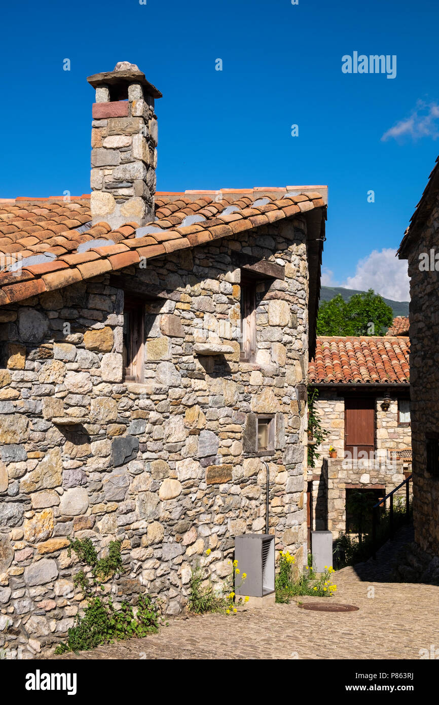 Terracotta tiled houses in La Roca village in the Catalonian Pyrenees ...