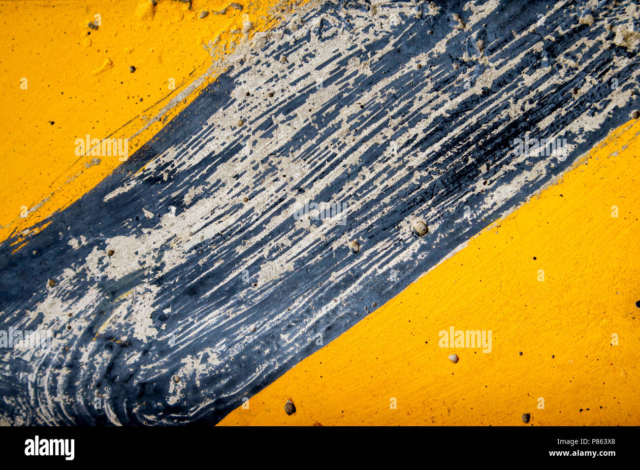 Yellow striped road markings on black asphalt Stock Photo - Alamy