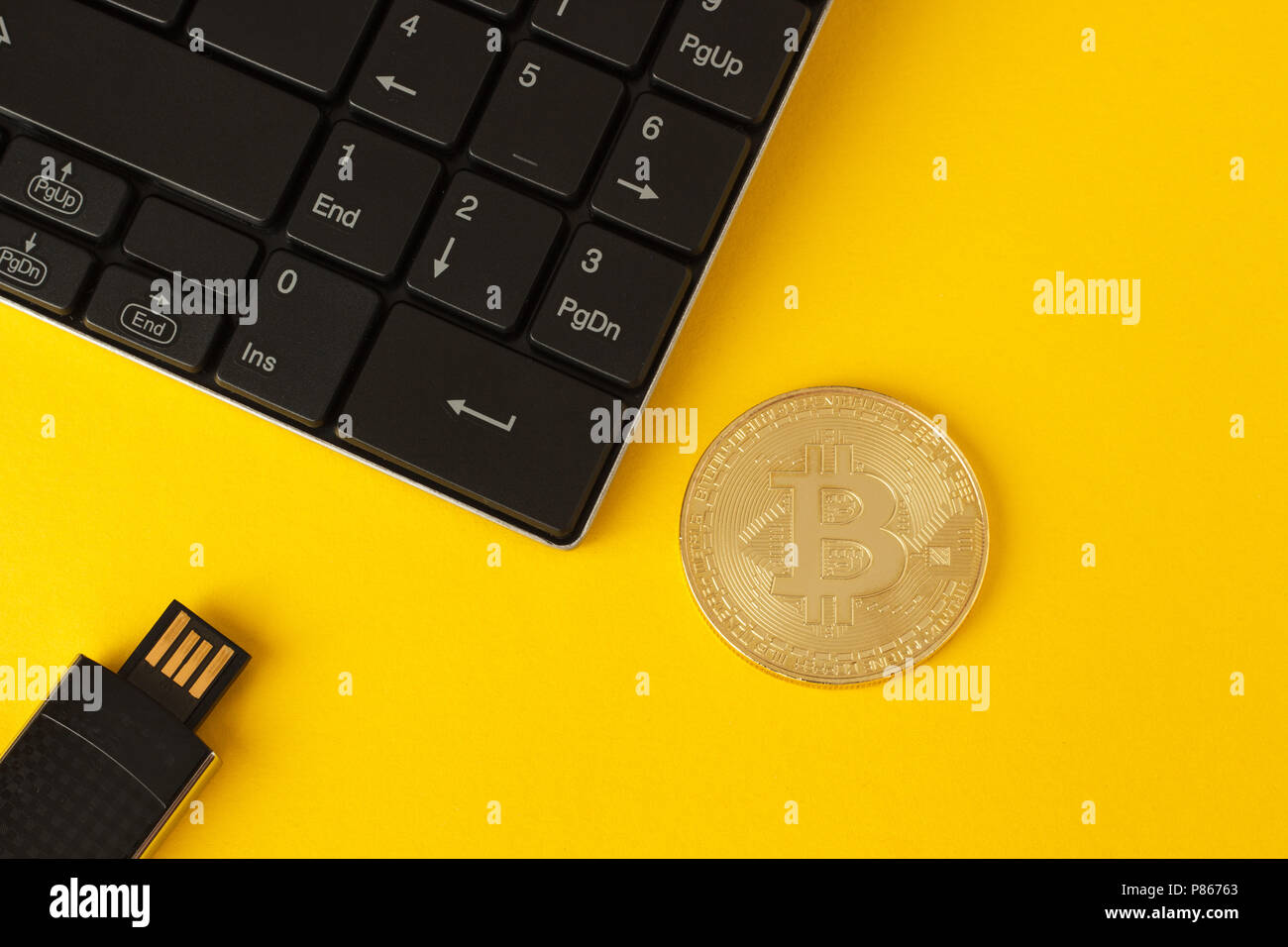 Golden bitcoin, keyboard and flash drive on a yellow background Stock ...