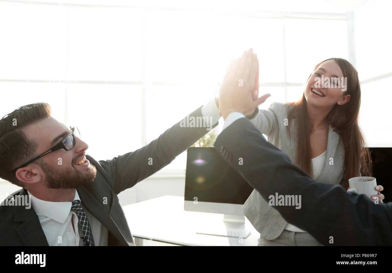 business team giving each other a high five Stock Photo - Alamy