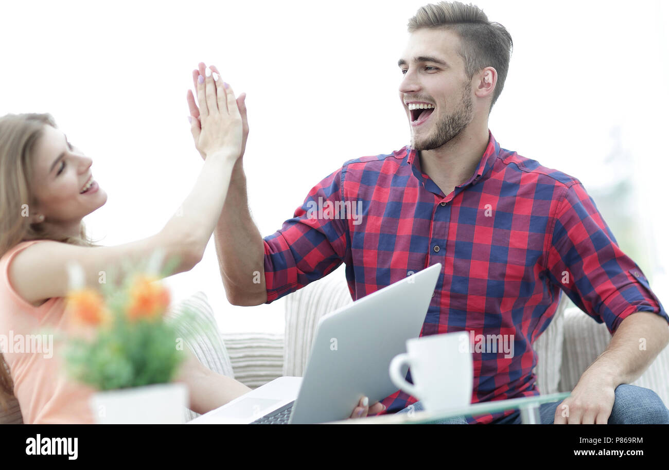 happy young couple giving each other a high five Stock Photo - Alamy