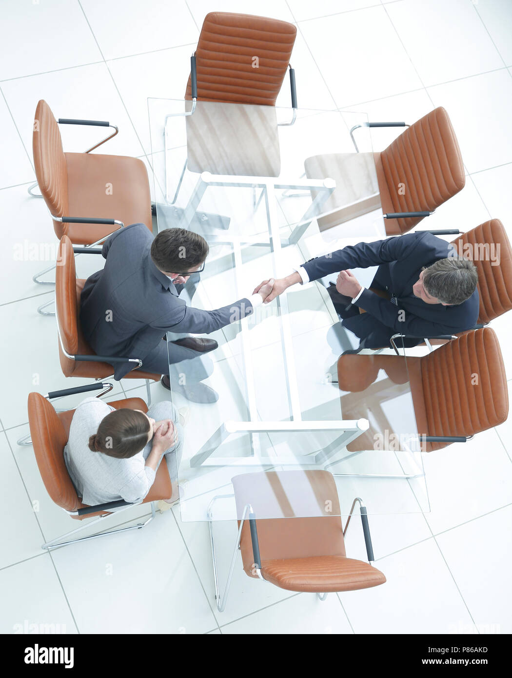 Handshake across table hi-res stock photography and images - Alamy