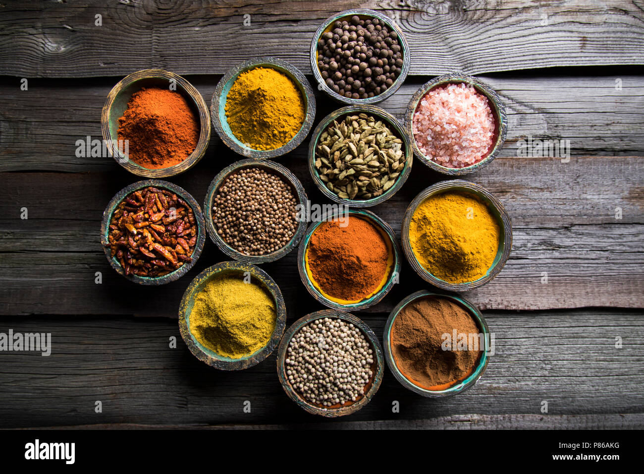 Wooden table of colorful spices Stock Photo - Alamy