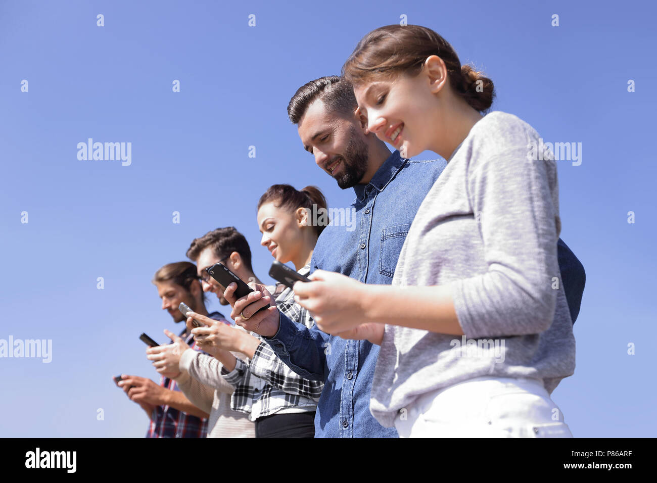 young people using smartphones to search network Stock Photo - Alamy