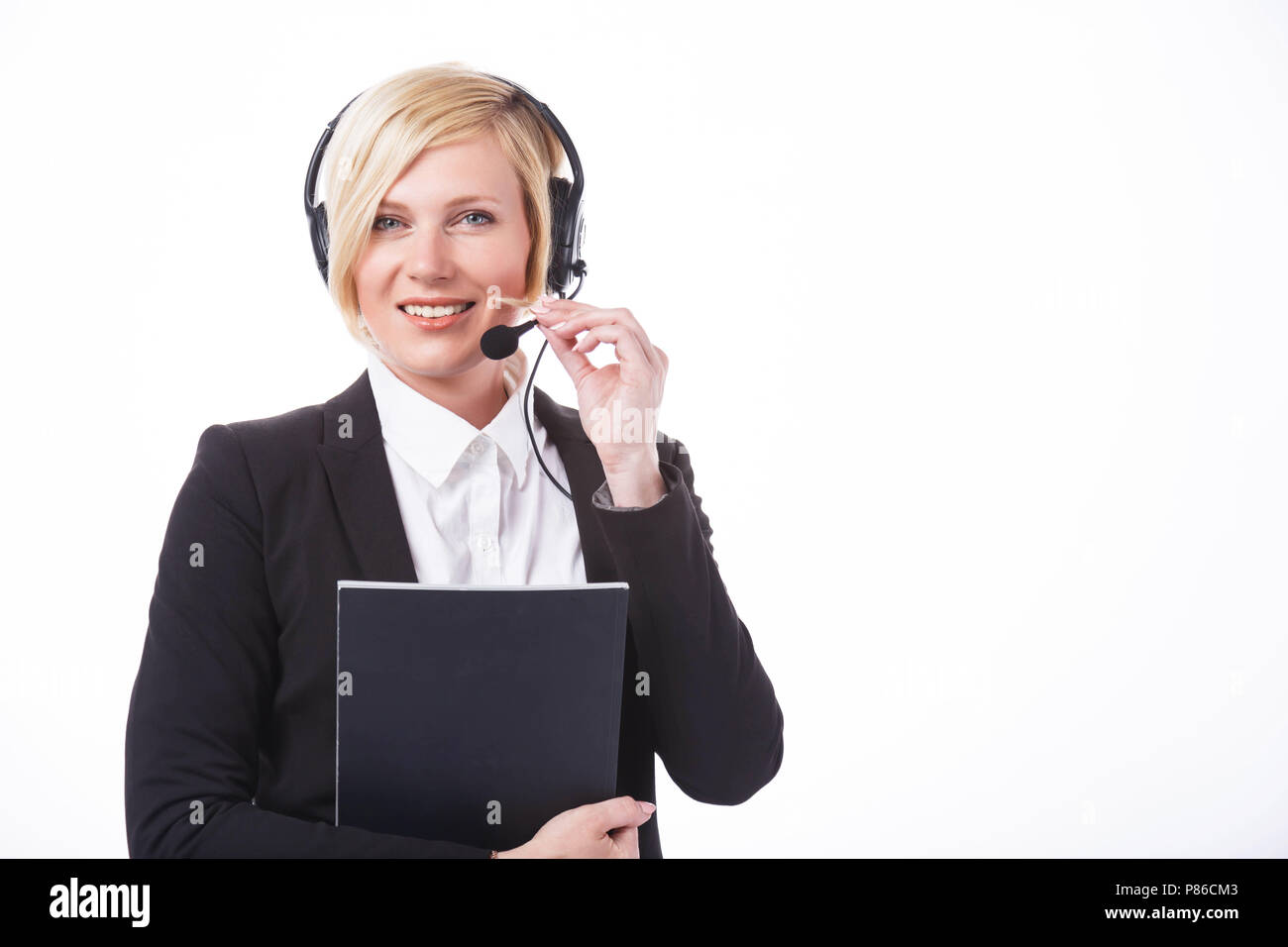 Smiling call center operator, blonde woman dressed in black jacket ...