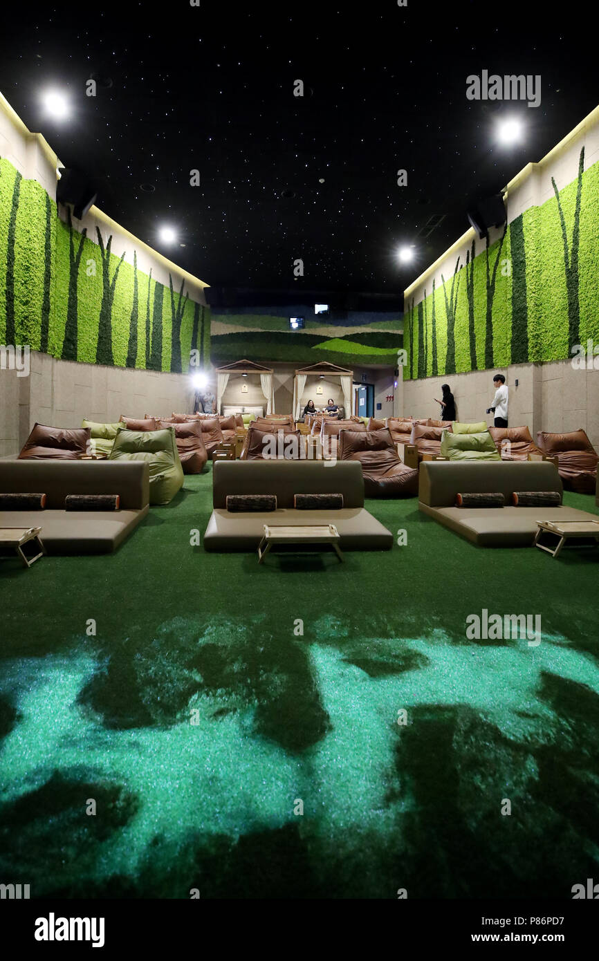 Seoul, South Korea. 10th July, 2018. Cinema with forest Moviegoers watch a film at a CGV "CINE ...