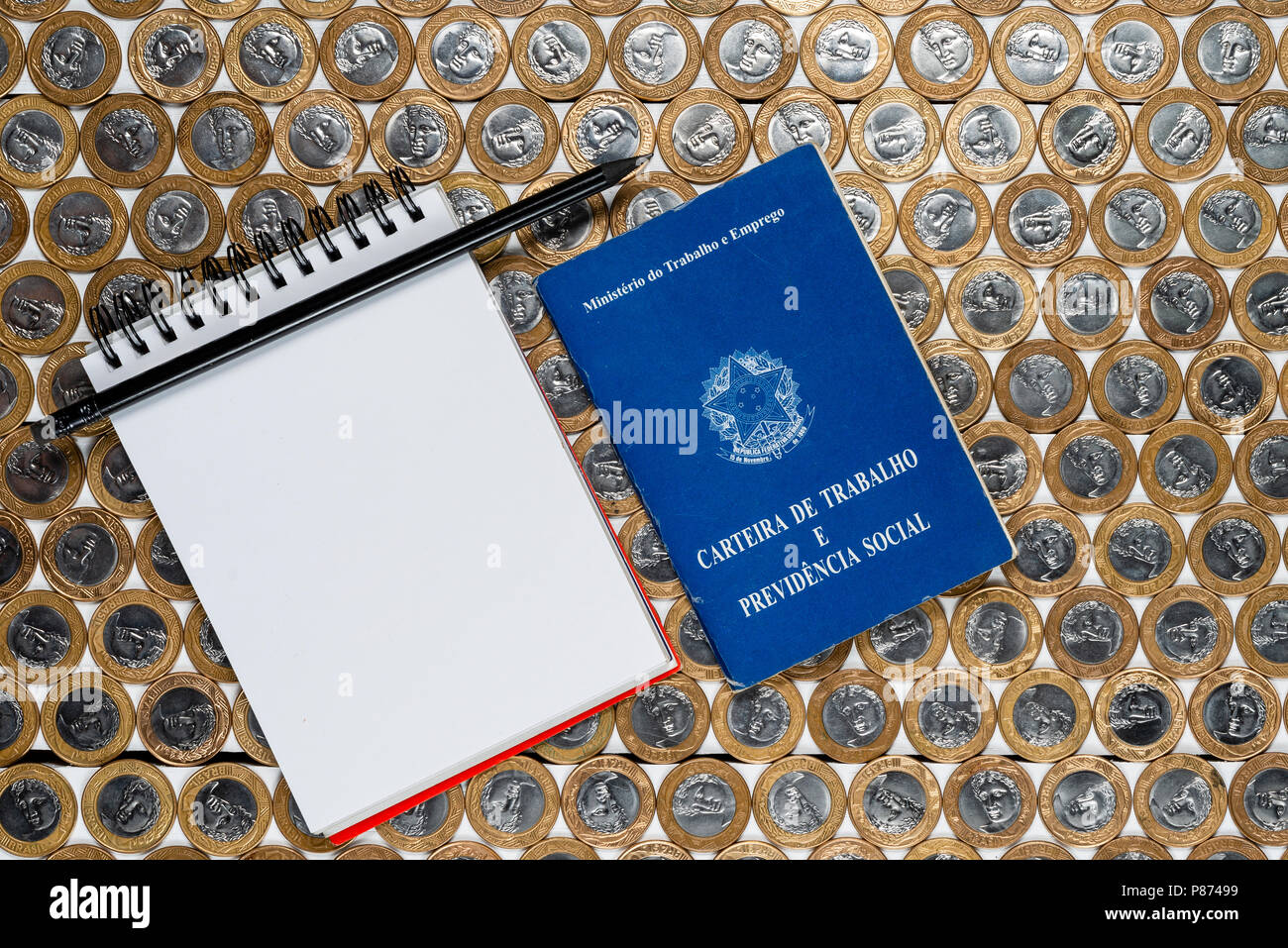 Work permit notepad and black pencil on several Brazilian one real ...