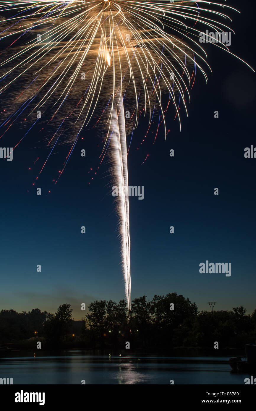 Vibrant firework explosions in the night sky at dusk Stock Photo - Alamy