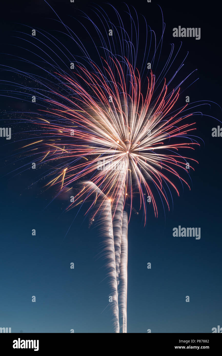 Vibrant firework explosions in the night sky at dusk Stock Photo - Alamy