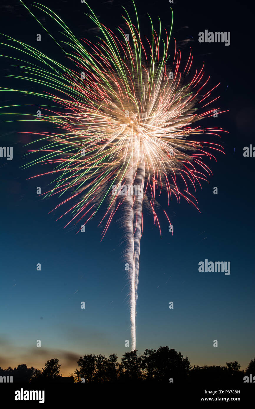 Vibrant firework explosions in the night sky at dusk Stock Photo - Alamy