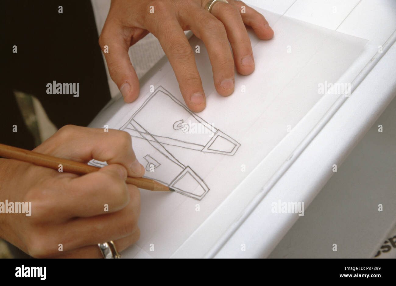 Close-up of hands tracing a drawing onto white paper Stock Photo - Alamy