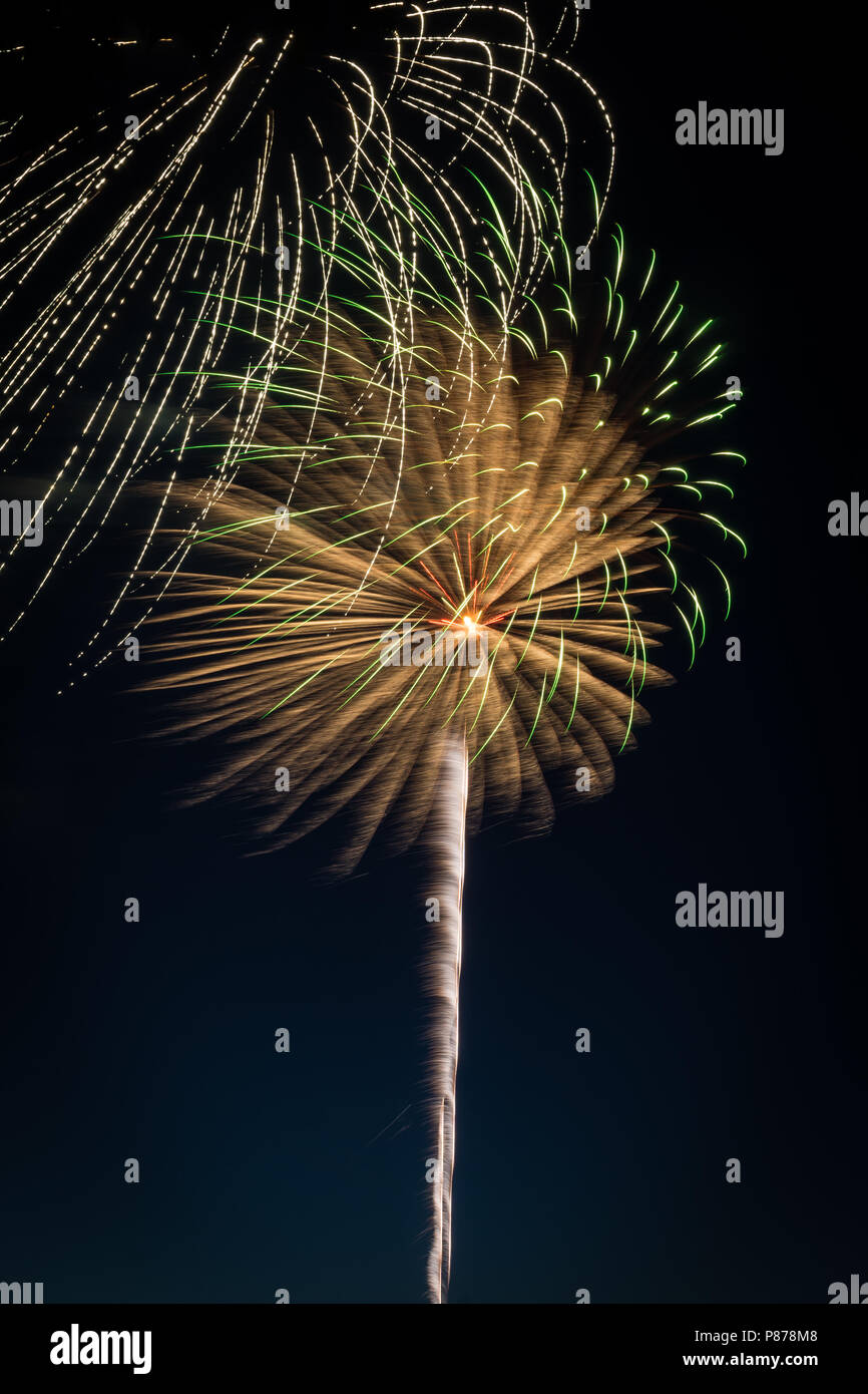 Vibrant firework explosions in the night sky at dusk Stock Photo - Alamy