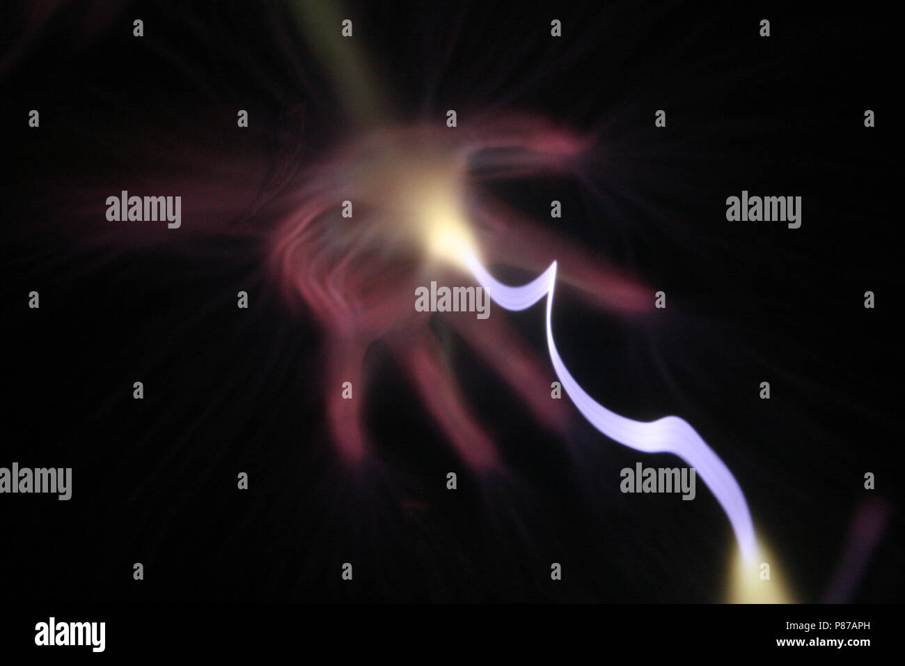 Hand on plasma lamp looks like bolt of electricity charging from hand ...