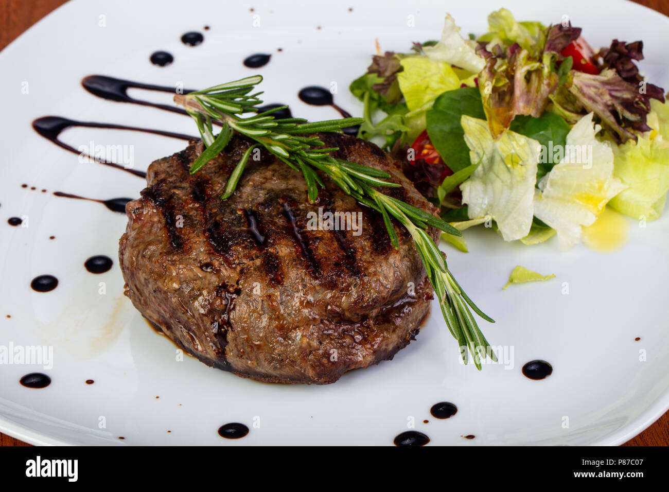 Delicious fried beef stake with salad Stock Photo - Alamy