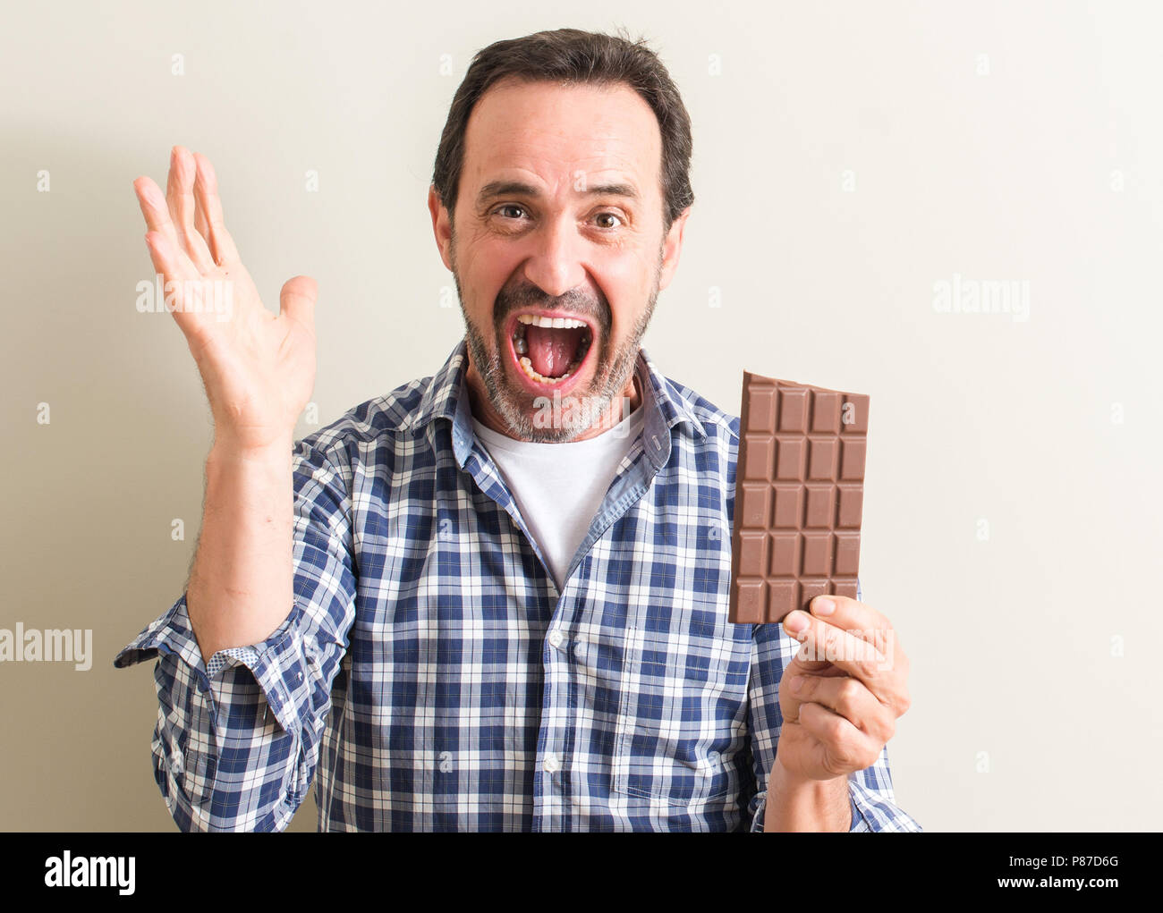 Guy eating chocolate bar and happy hi-res stock photography and images ...