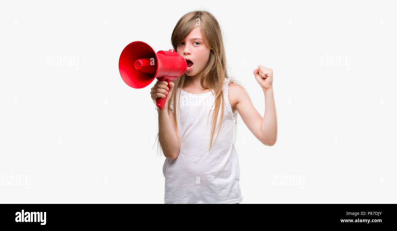 Young blonde toddler holding megaphone annoyed and frustrated shouting ...