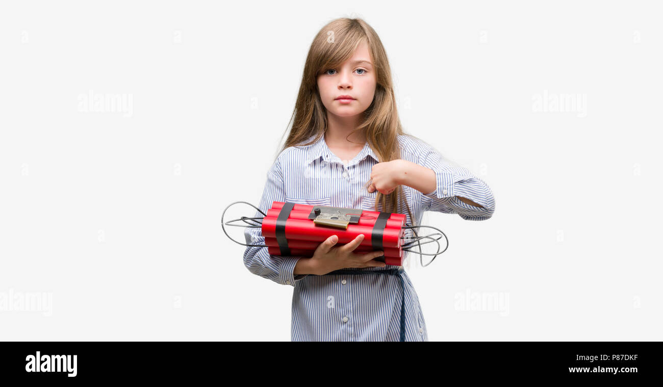 Young blonde child holding dynamite bomb with surprise face pointing ...