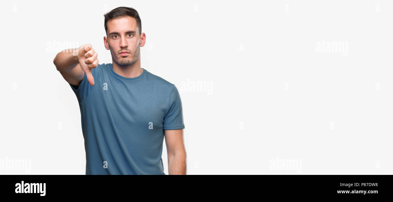 Handsome young casual man looking unhappy and angry showing rejection ...