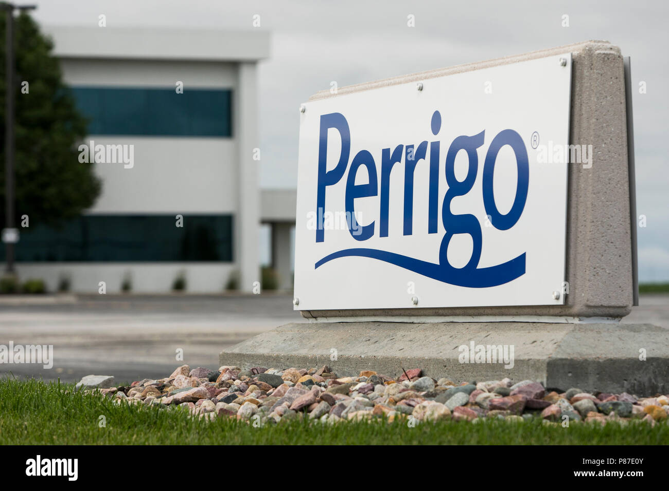 A logo sign outside of a facility occupied by the Perrigo Company in ...