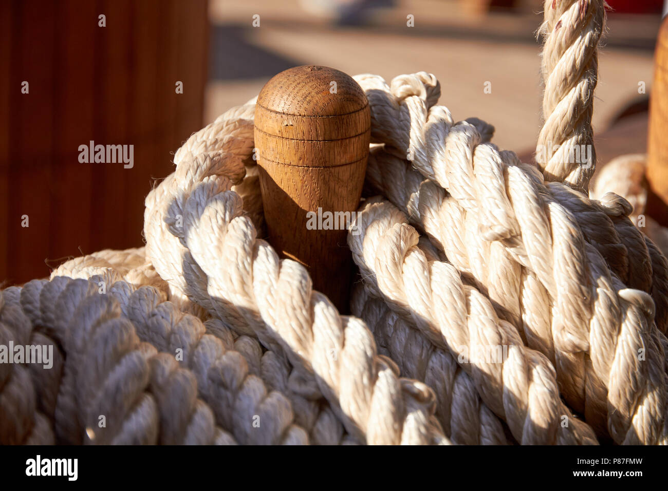 Marine background, sailing boat block with old rope Stock Photo - Alamy
